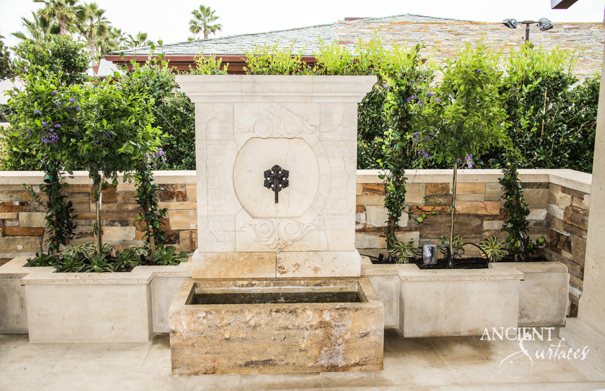Crafting Outdoor Ambiance with Unique Reclaimed Limestone Wall Fountains